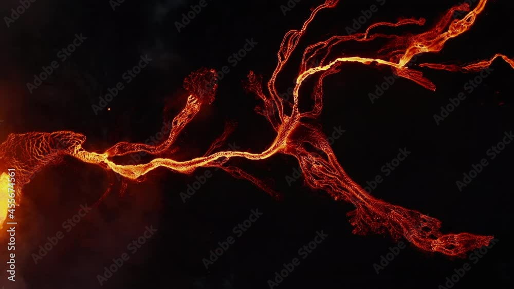 Aerial birds eye overhead top down panning view of molten lava stream ...