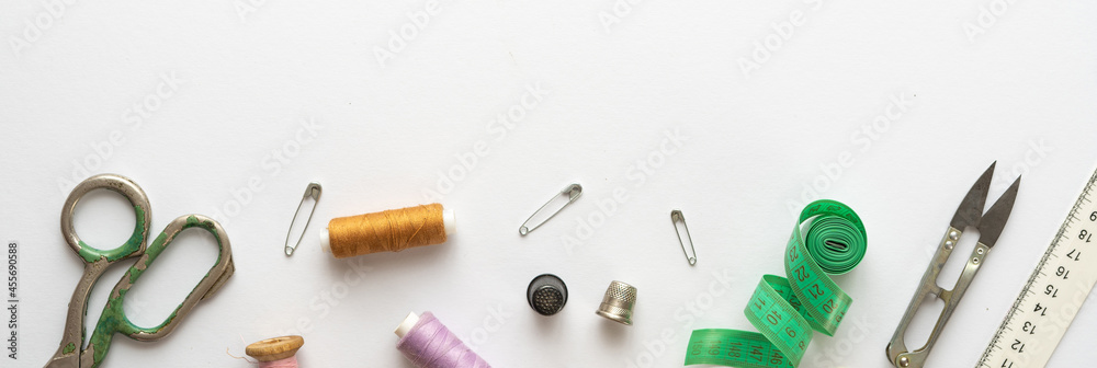 Flat lay composition with threads, scissors, buttons, needles, pins and ...