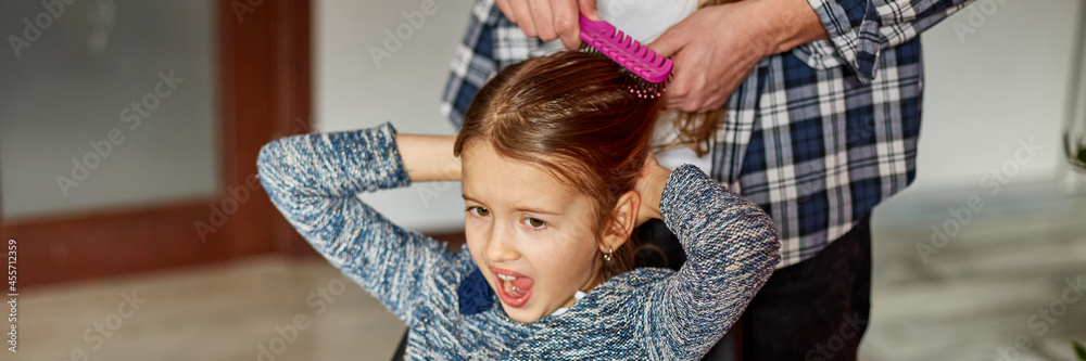 Banner of Father combing, brushing his daughter's hair at home, child ...