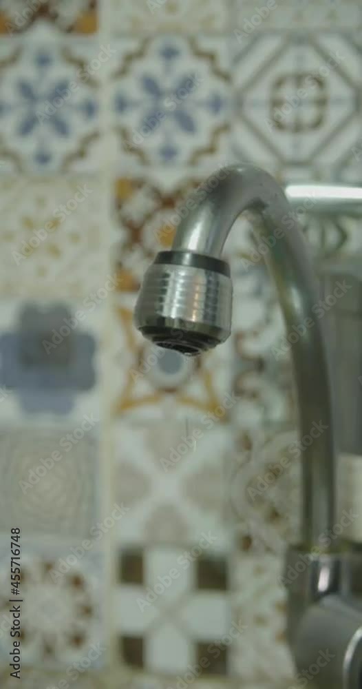 Dripping faucet. Waste of water in the kitchen faucet. Water waste ...