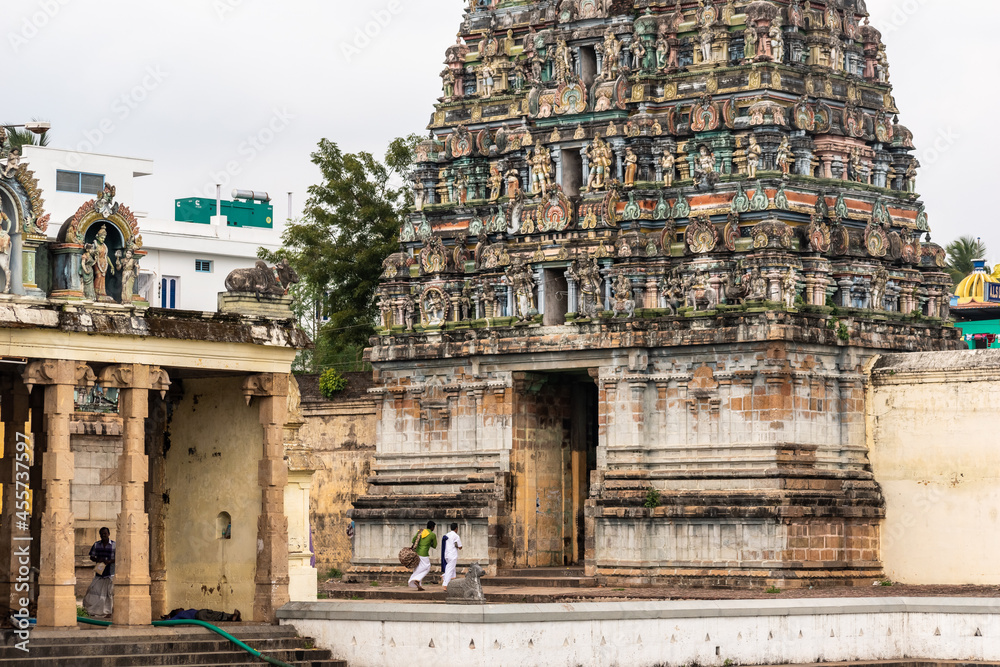The facade of the weathered gopuram tower of the ancient Hindu ...