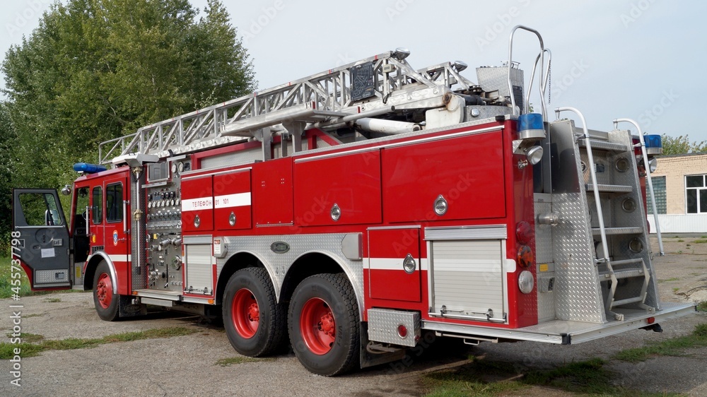 Fire truck with retractable ladder for extinguishing fires at height. A ...