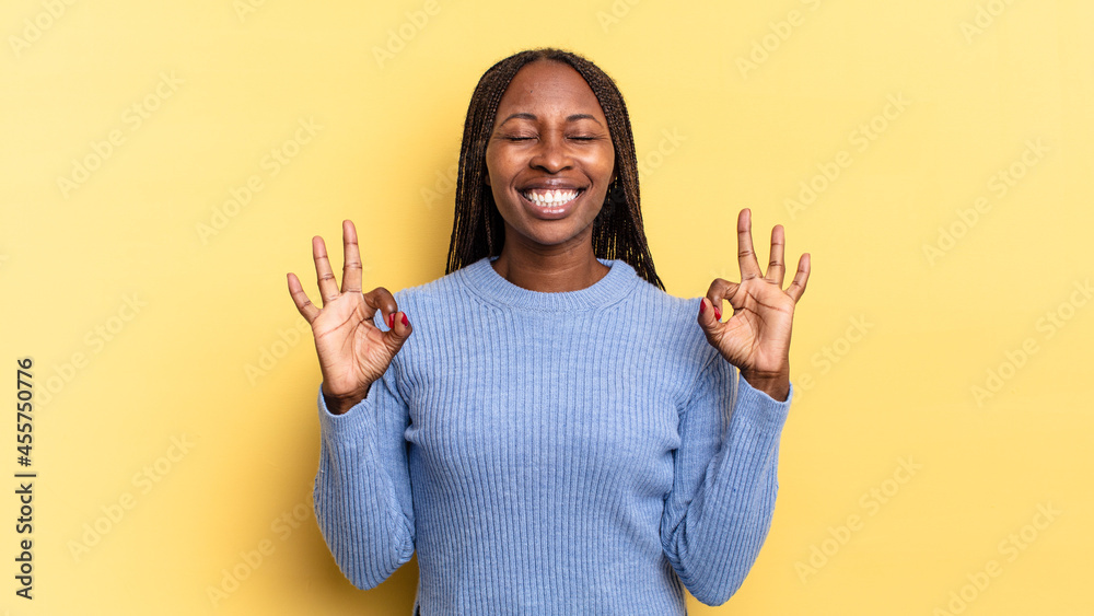 afro black pretty woman looking concentrated and meditating, feeling ...