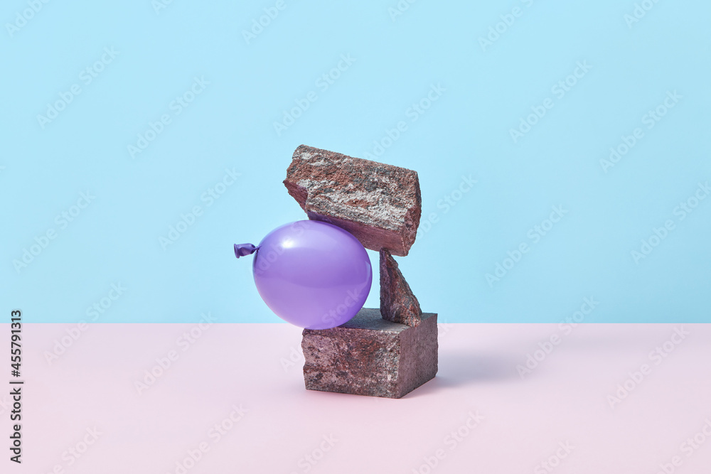 Balloon squeezed between stones Stock Photo | Adobe Stock