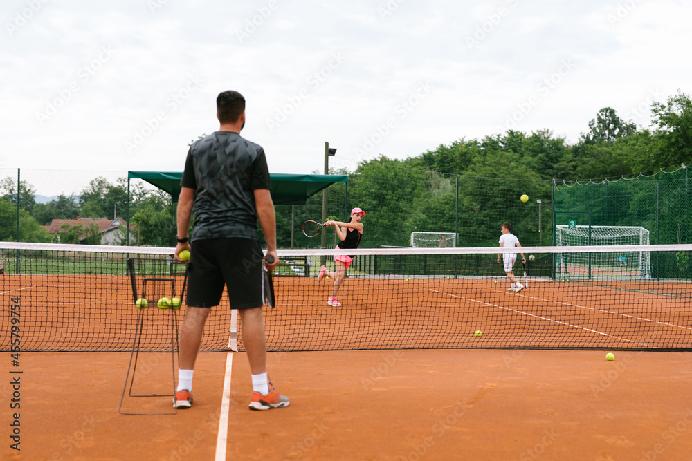 Tennis coach working with his students on a tennis court Stock Photo ...