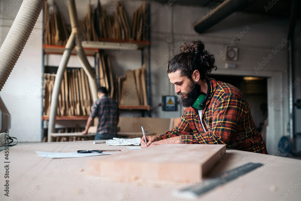 Carpenter Writing Down Ideas Stock Photo | Adobe Stock