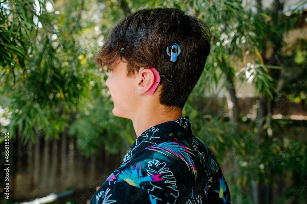 Side view of teen boy with Cochlear implants Stock Photo | Adobe Stock