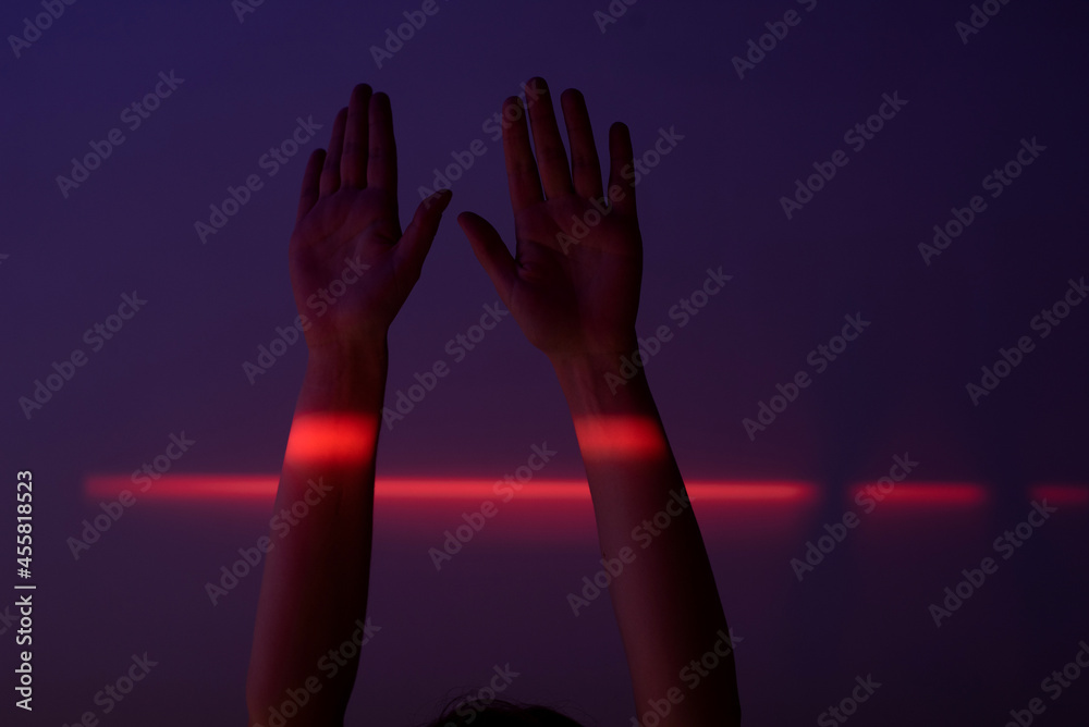 Neon red light on hands Stock Photo | Adobe Stock