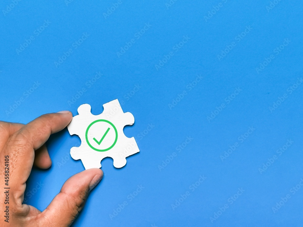 Verification or agreement concept. Hand hold a piece of jigsaw puzzle ...