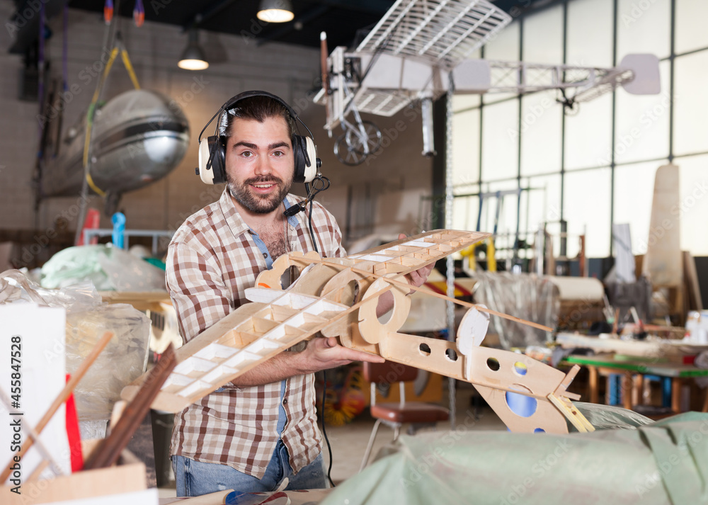 Smiling young man in pilot aviation headsets having fun with light ...