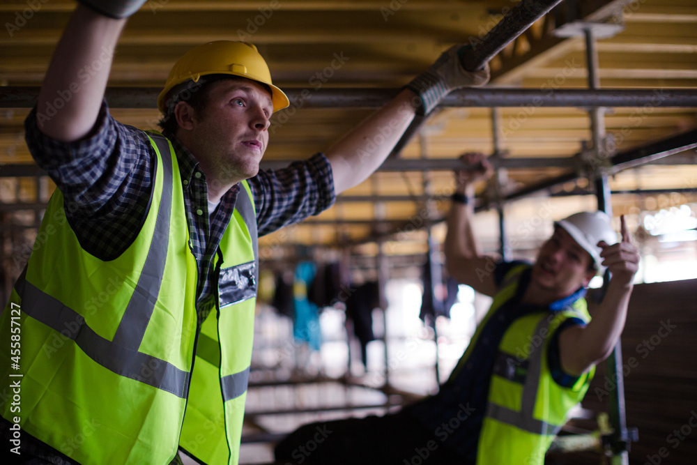 Constructor workers assembling rebar structure at construction site ...