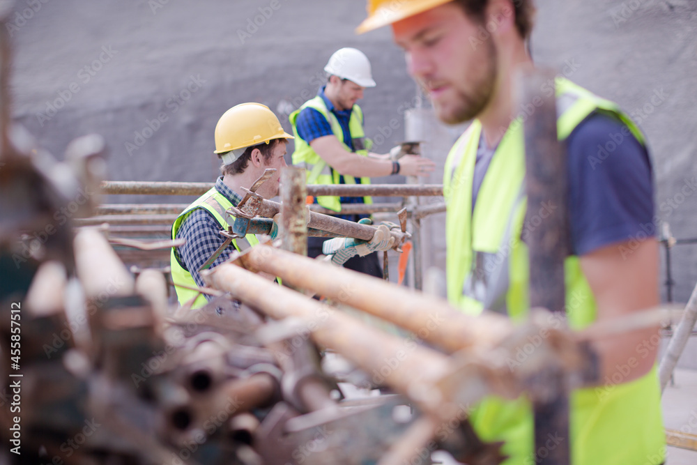 Constructor workers assembling rebar structure at construction site ...