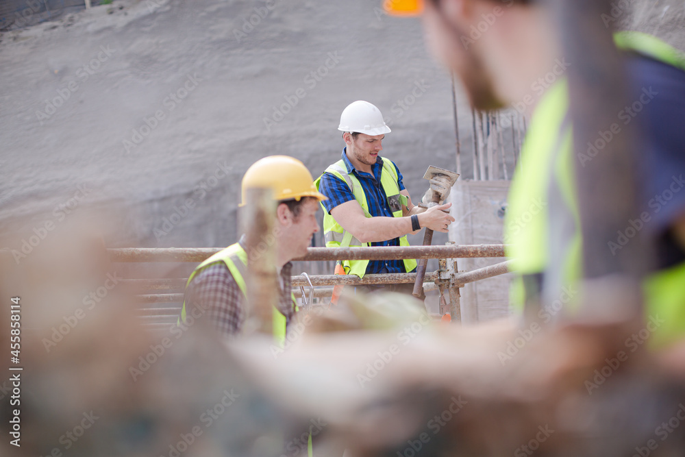 Constructor workers assembling rebar structure at construction site ...