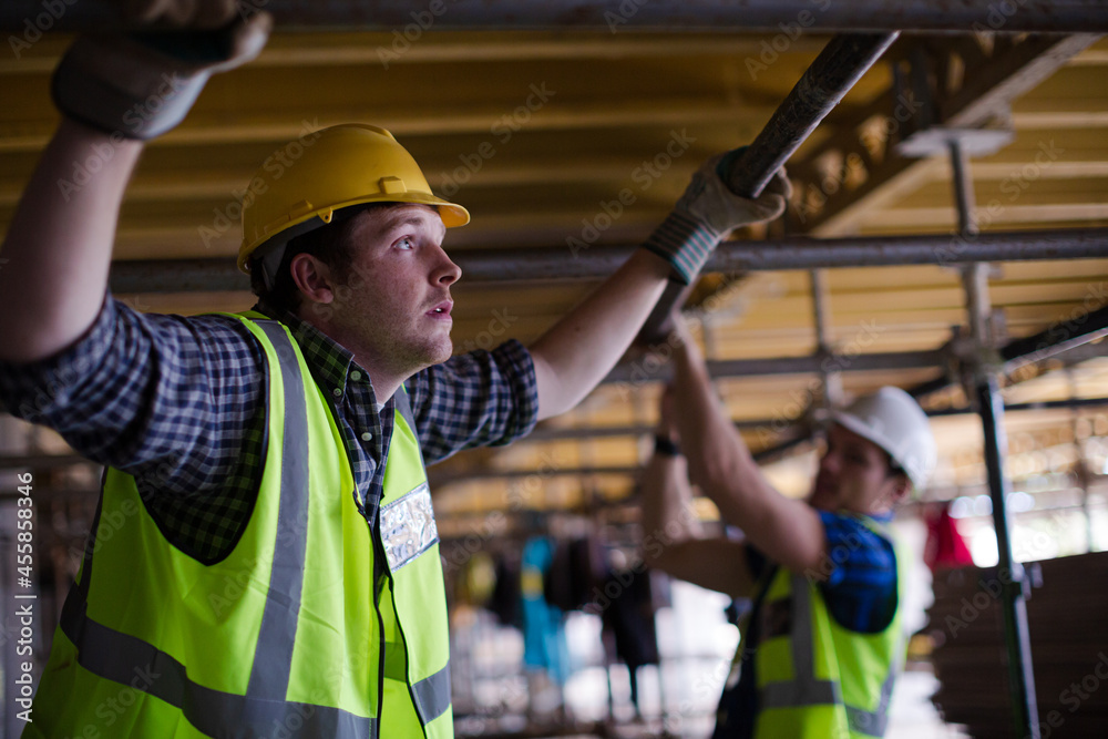 Constructor workers assembling rebar structure at construction site ...