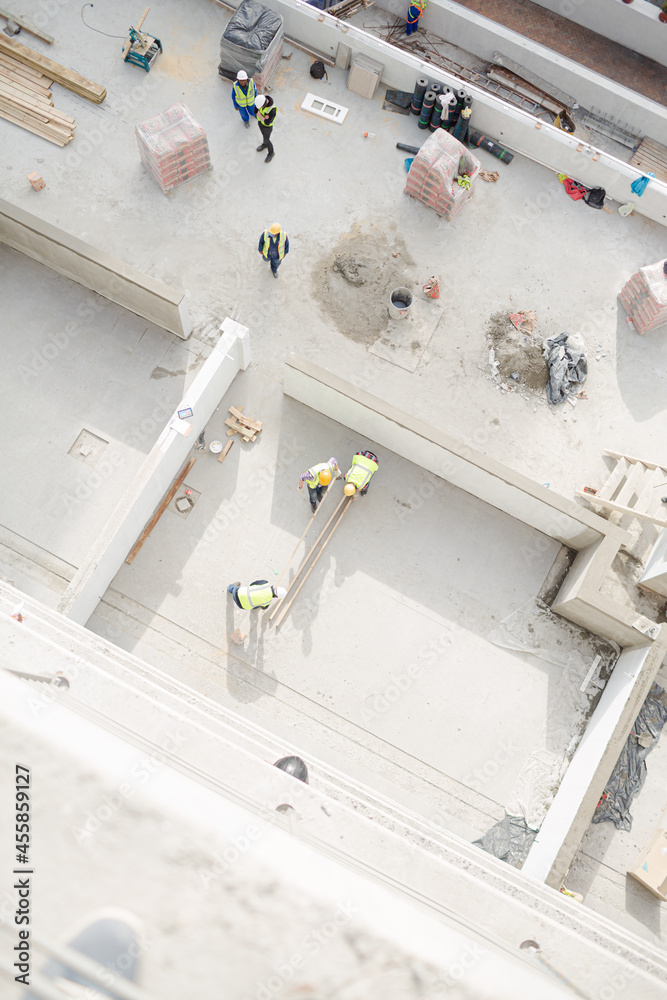 Overhead view of construction workers at construction site Stock Photo ...