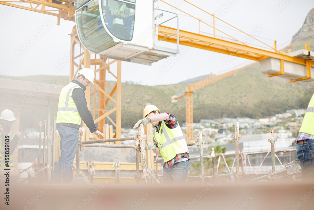 Constructor workers assembling rebar structure at construction site ...