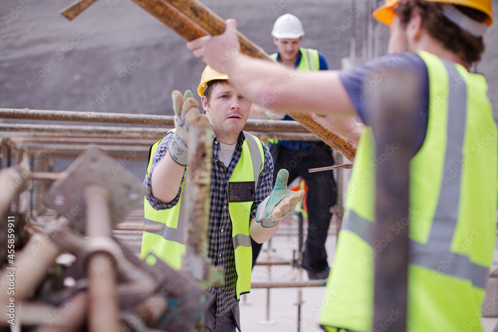 Constructor workers assembling rebar structure at construction site ...