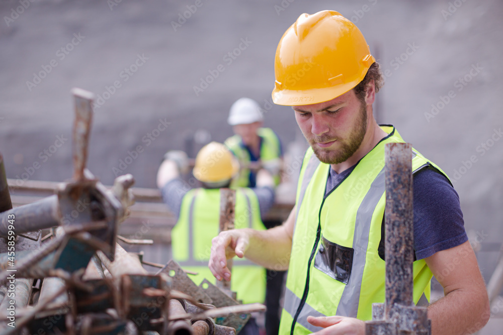 Constructor workers assembling rebar structure at construction site ...