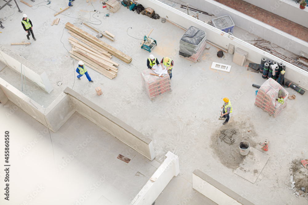 Overhead view of construction workers at construction site Stock Photo ...