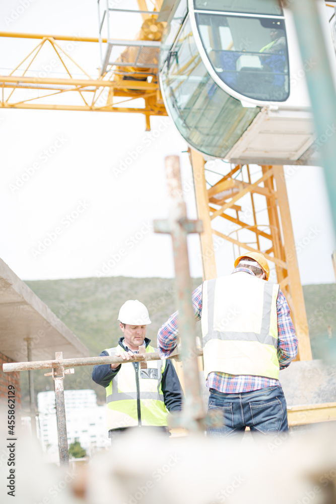 Constructor workers assembling rebar structure at construction site ...