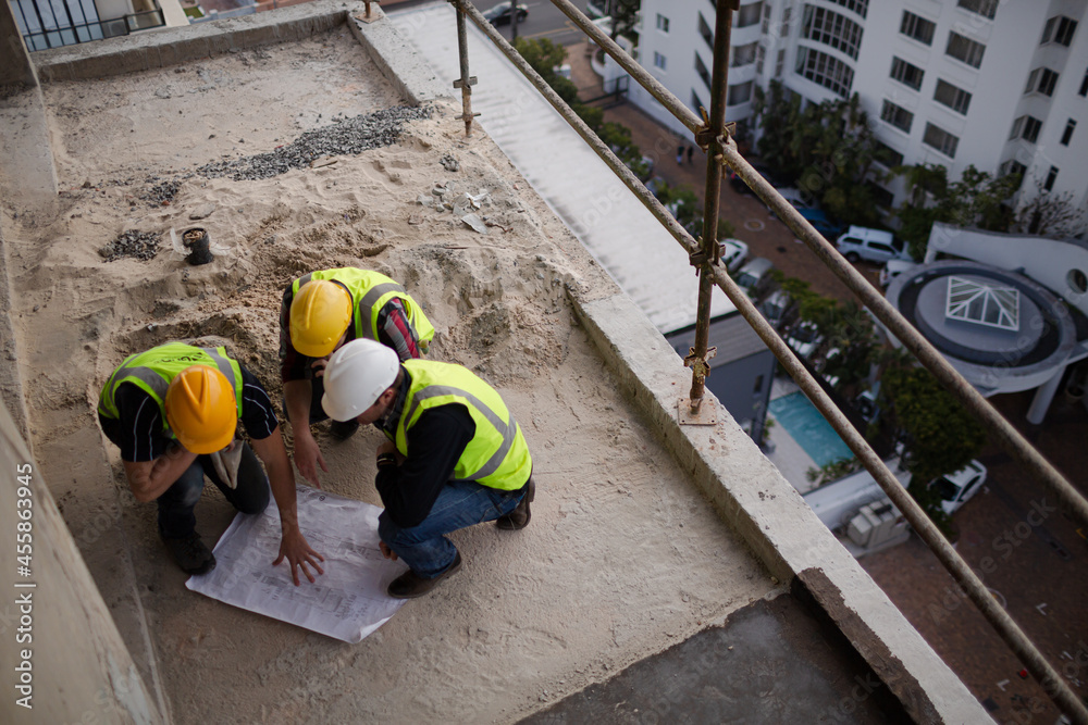 Overhead view of construction workers laying concrete at construction ...