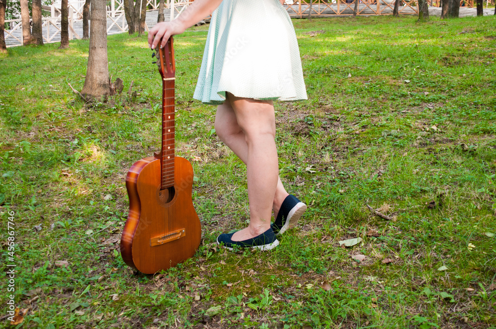 Women's legs and guitar in the summer in the park Stock Photo | Adobe Stock