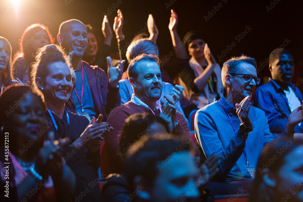 Excited audience clapping in dark room Stock Photo | Adobe Stock