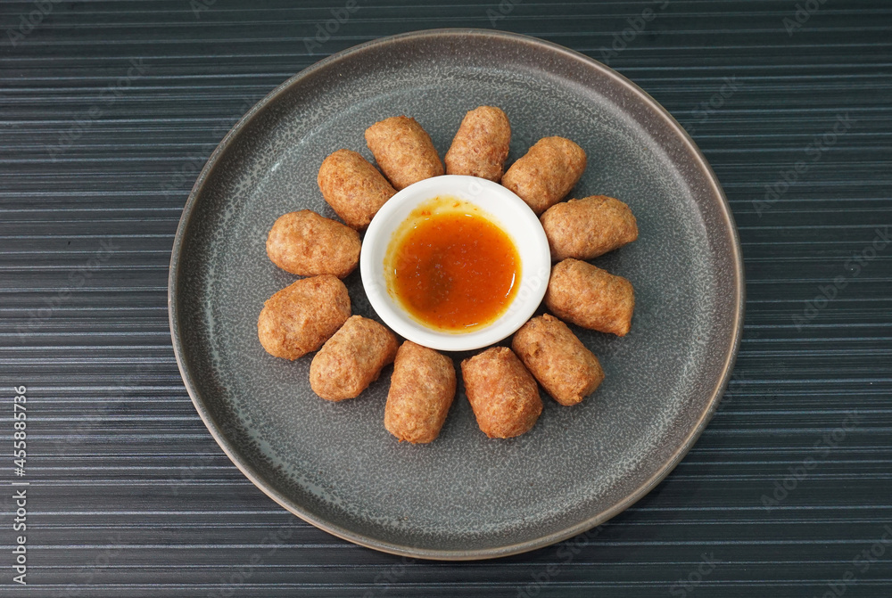 deep fried mini hot dog sausage luncheon meat with spicy sauce on dark ...