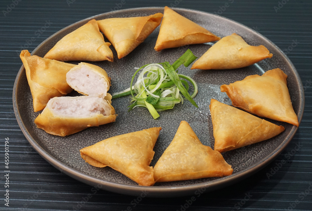 deep fried crispy yam taro spring roll samosa on dark grey wood ...