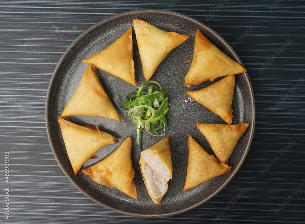 deep fried crispy yam taro spring roll samosa on dark grey wood ...