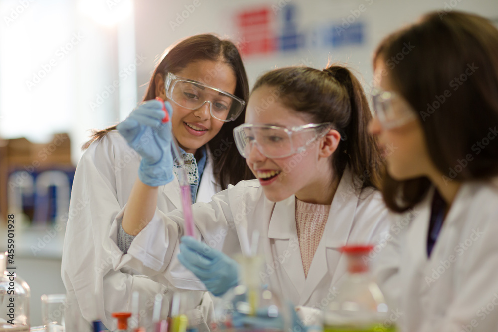 Girl students conducting scientific experiment in laboratory classroom ...