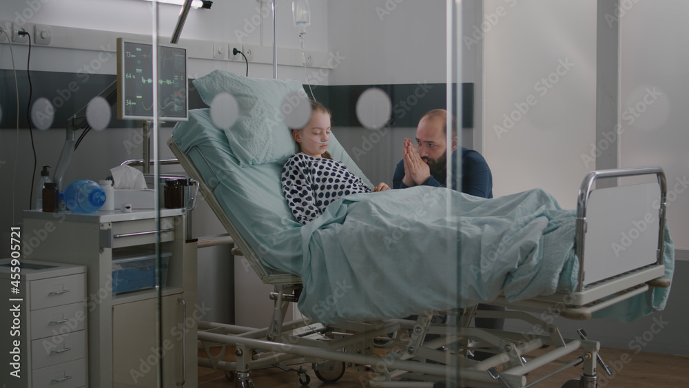 In hospital ward sick girl patient sleeping while worried father ...
