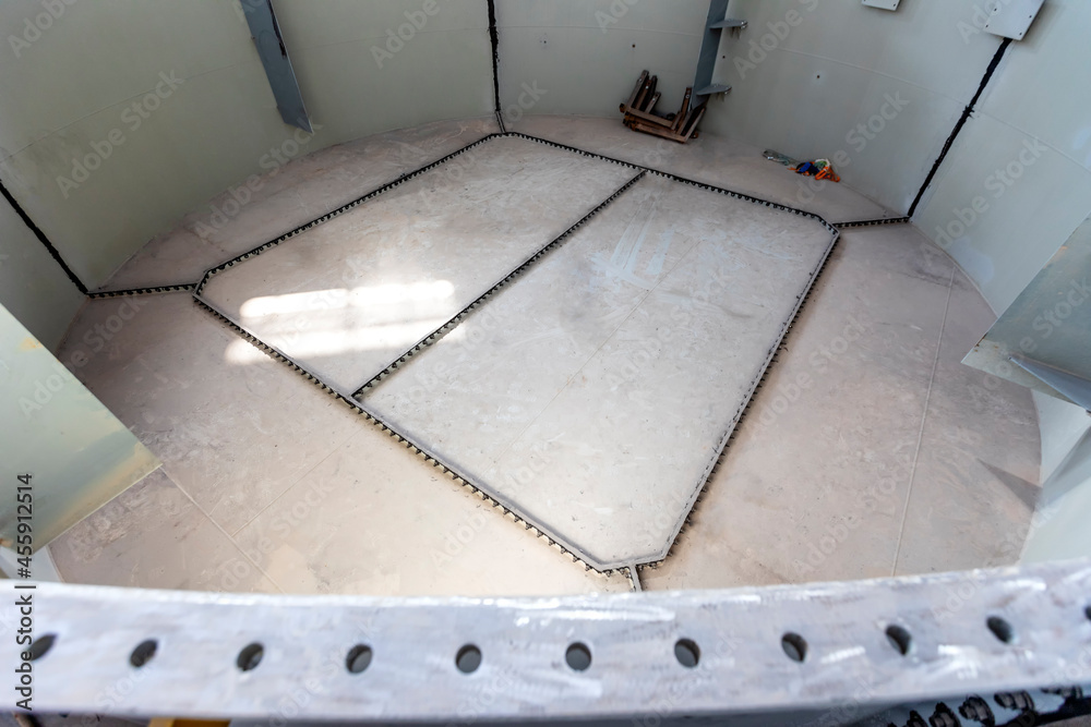 View of inside and bottom and shell plate of bolted storage tank. It ...