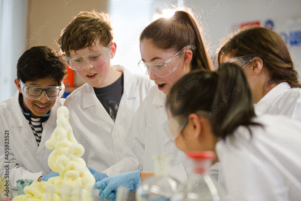 Surprised students conducting scientific experiment, watching chemical ...