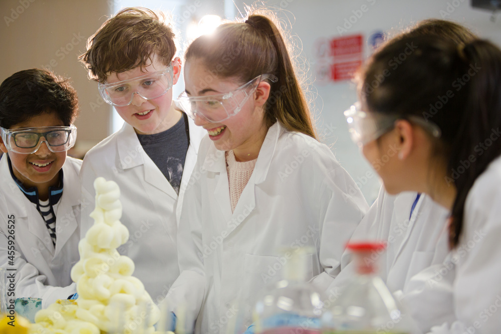 Surprised students conducting scientific experiment, watching chemical ...