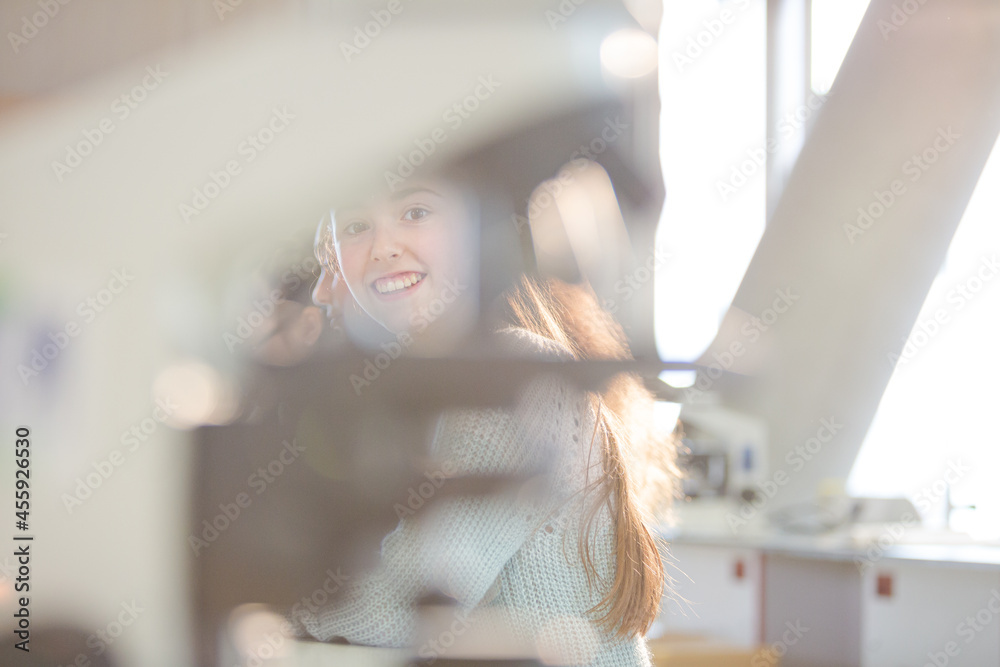 Girl student using microscope, conducting scientific experiment in ...