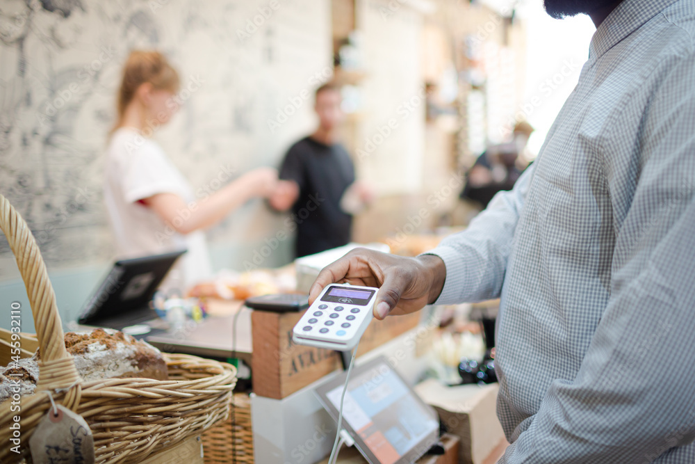 Cashier using touch screen cash register in grocery store Stock Photo ...