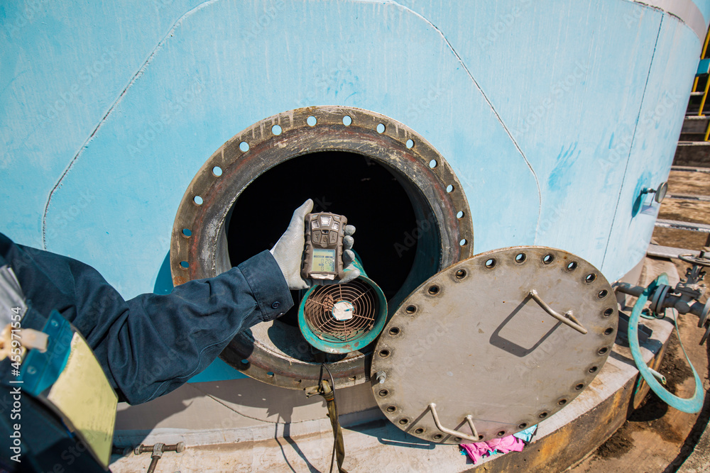 Worker hand holding gas detector inspection safety gas testing at front ...