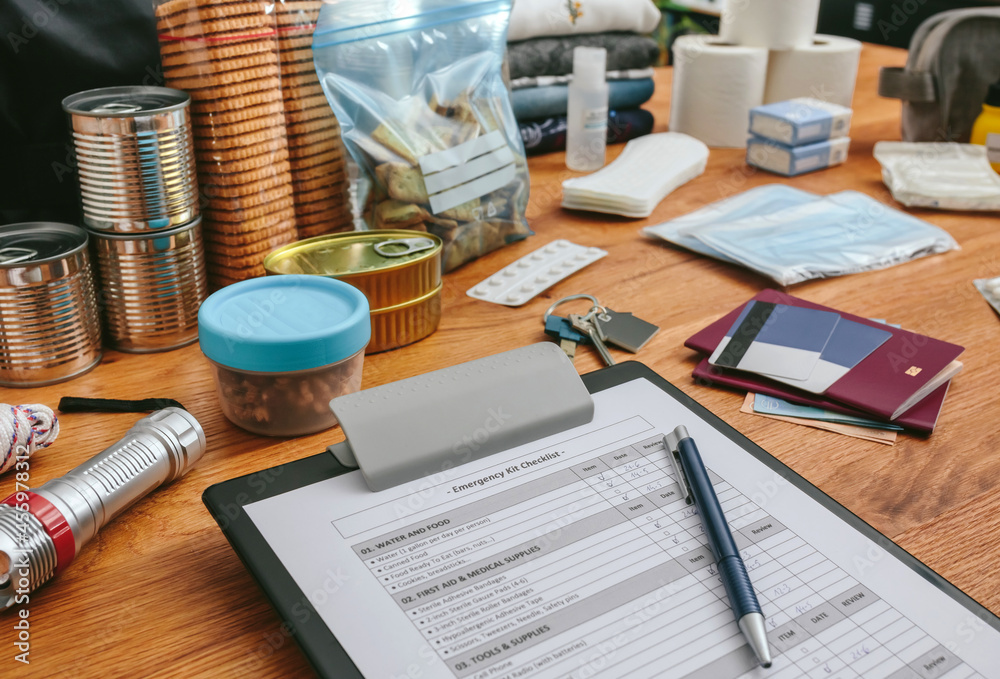 Emergency backpack checklist with necessities prepared on the table ...