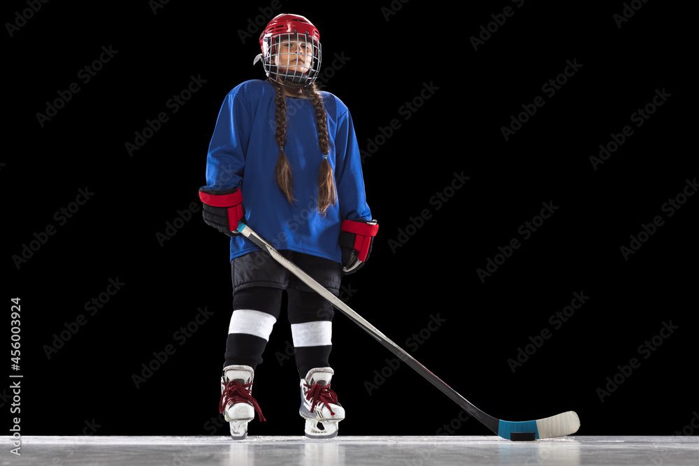 One child girl, hockey player wearing special uniform, holding hockey ...