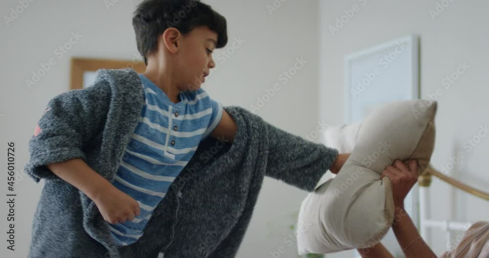 playful little boy playing fun game with mother at home cute kid ...
