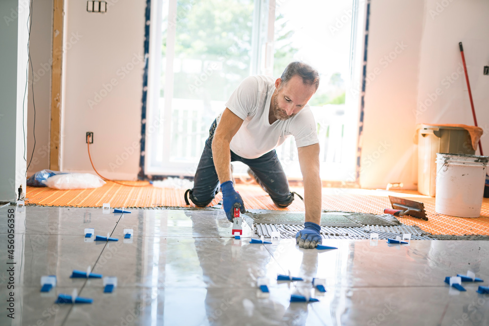nice handyman install tile on the floor Stock Photo | Adobe Stock