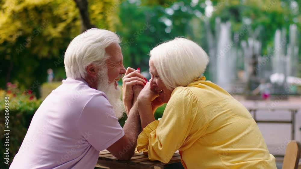 Attractive old woman and her partner good looking old man at the cafe ...