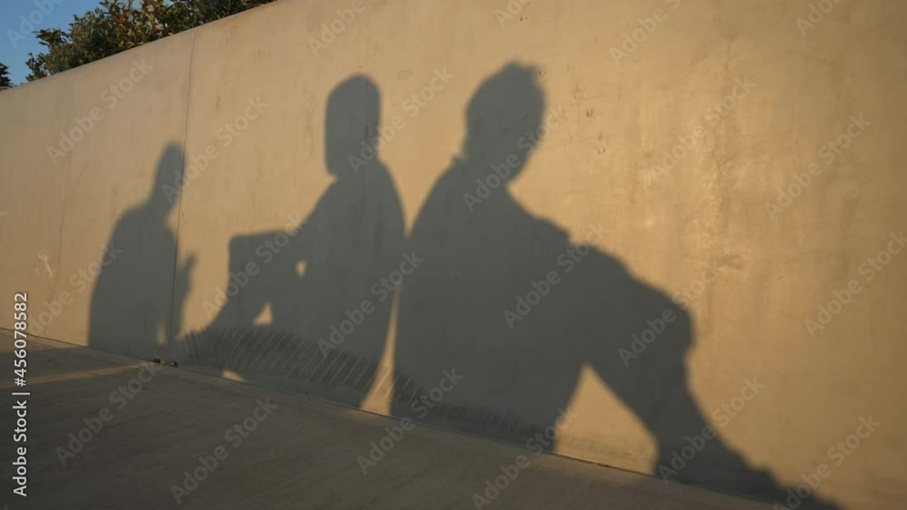 Shadows of argued couple sitting back to back as male silhouette ...