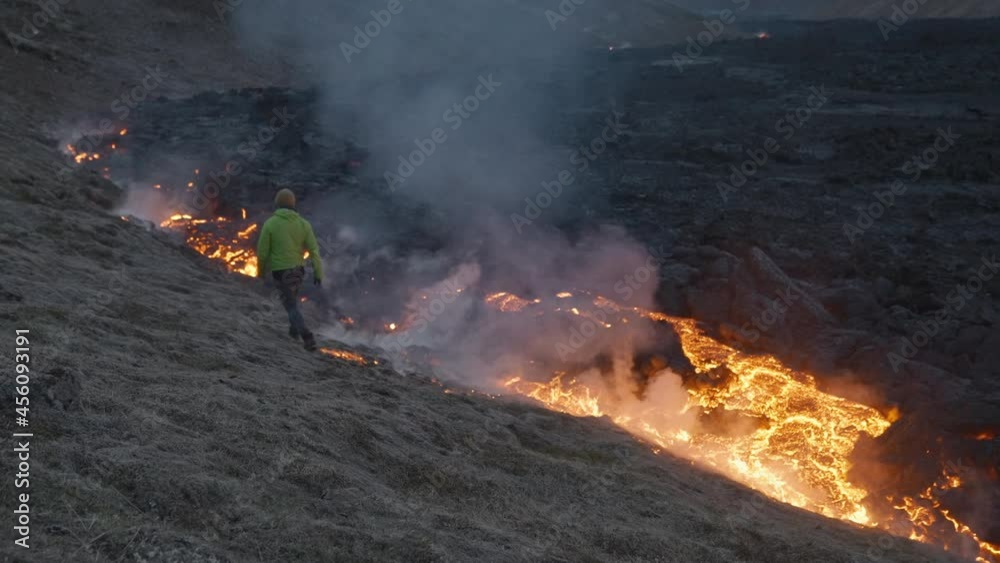 Man Walking Alongside Lava Flow From Erupting Fagradalsfjall Volcano ...