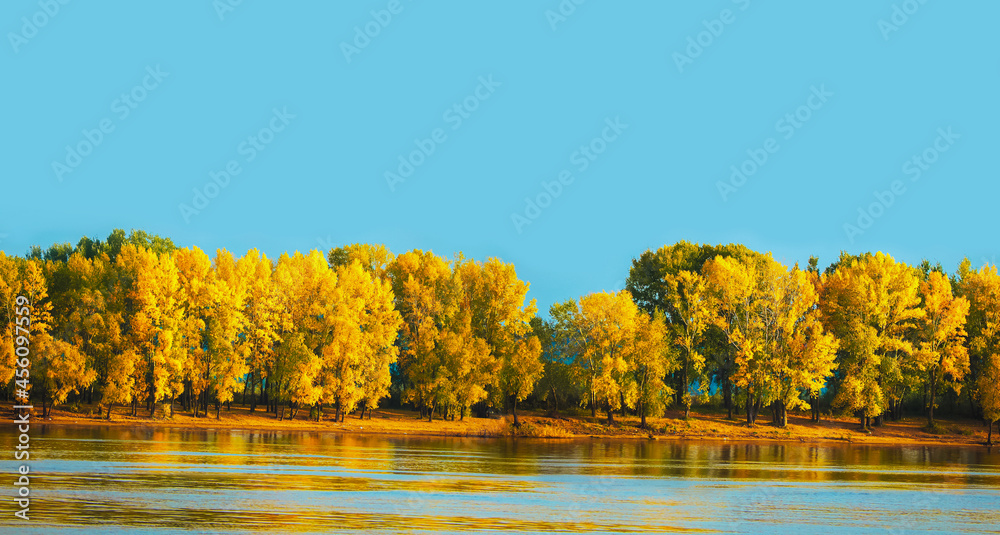 Autumn nature. Reflection on the water with a wisp of wind ripples ...