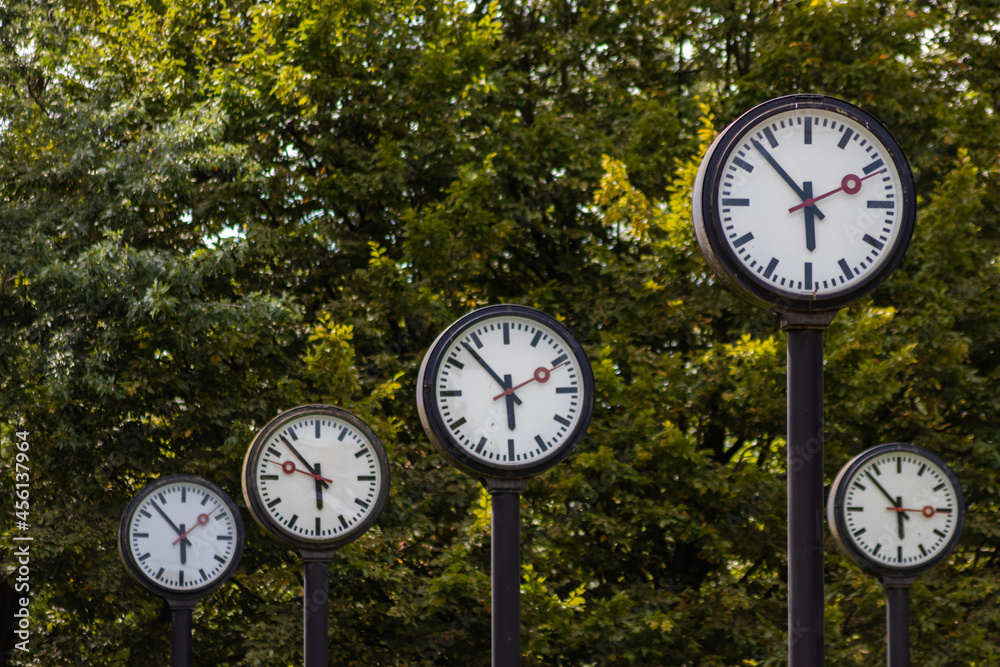 Classic black and white analog clocks with synchronized time show ...