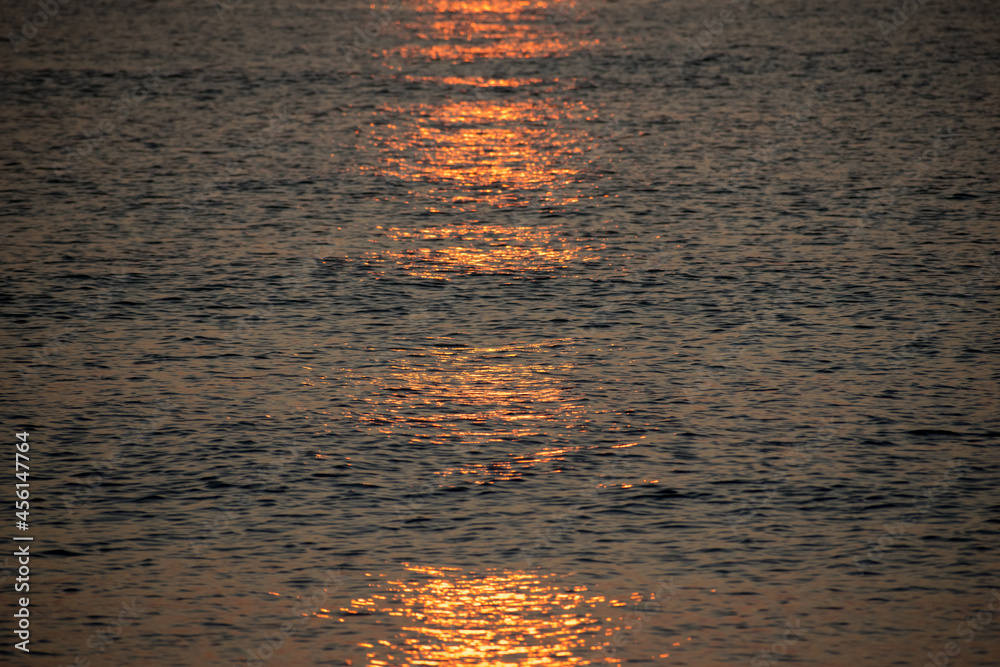 The reflection of the sun rising in the sea water. Texture. Stock Photo ...