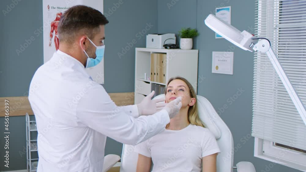 Doctor taking a patient in the office of aesthetic medicine. Doctor ...