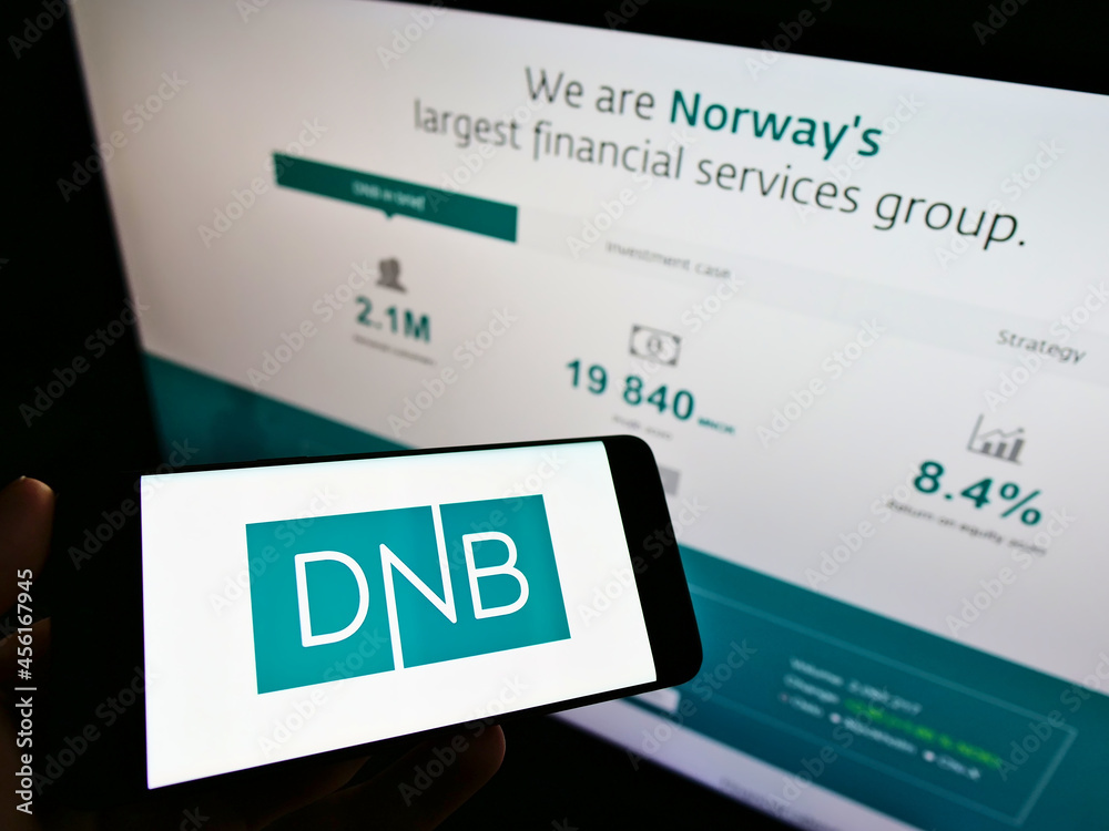 STUTTGART, GERMANY - Mar 07, 2021: Person holding cellphone with logo ...